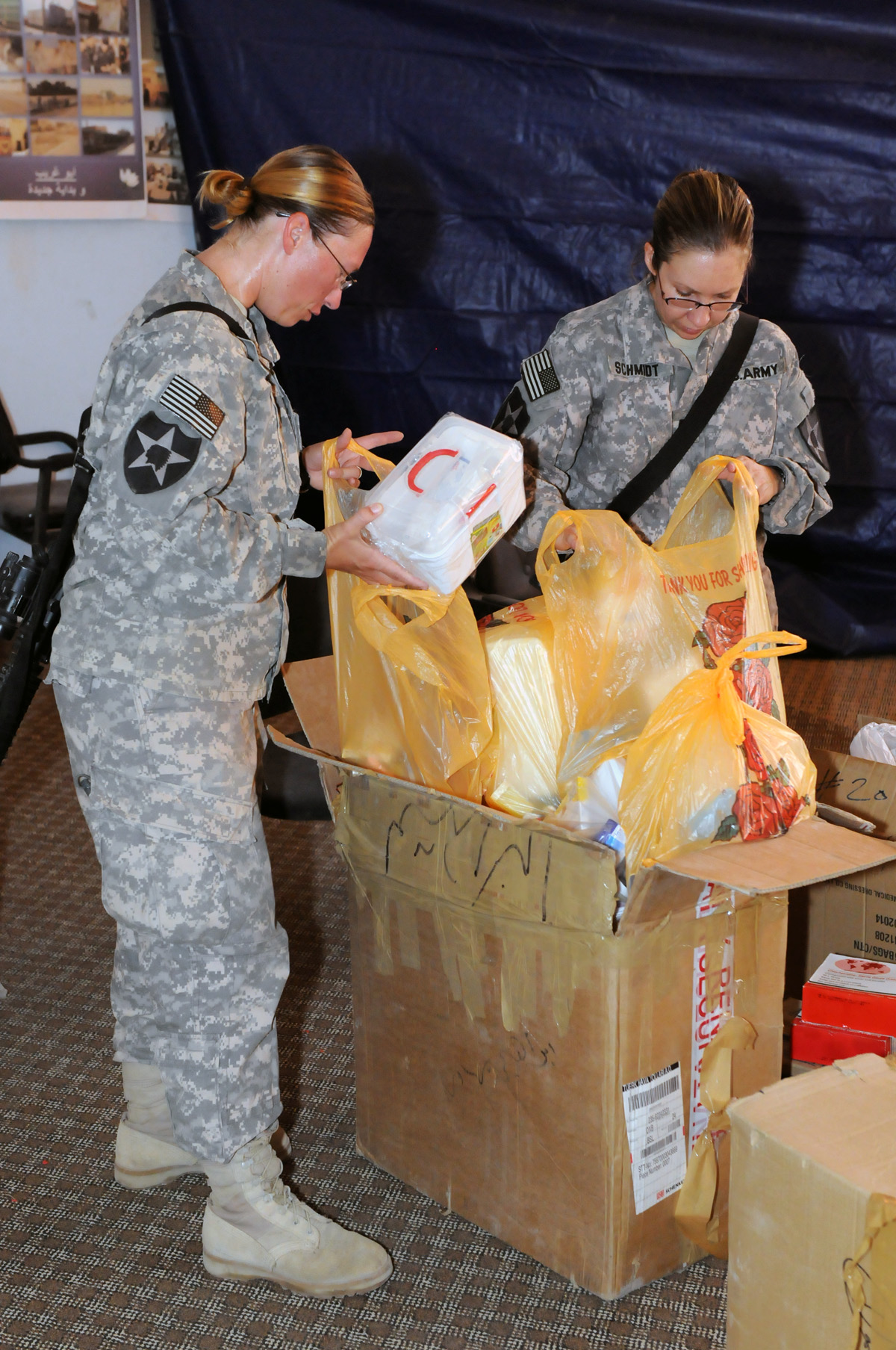 U.S. Army Capt. Rebecca Schmidt, right, and Spc. Lisa Roberts unpack ...