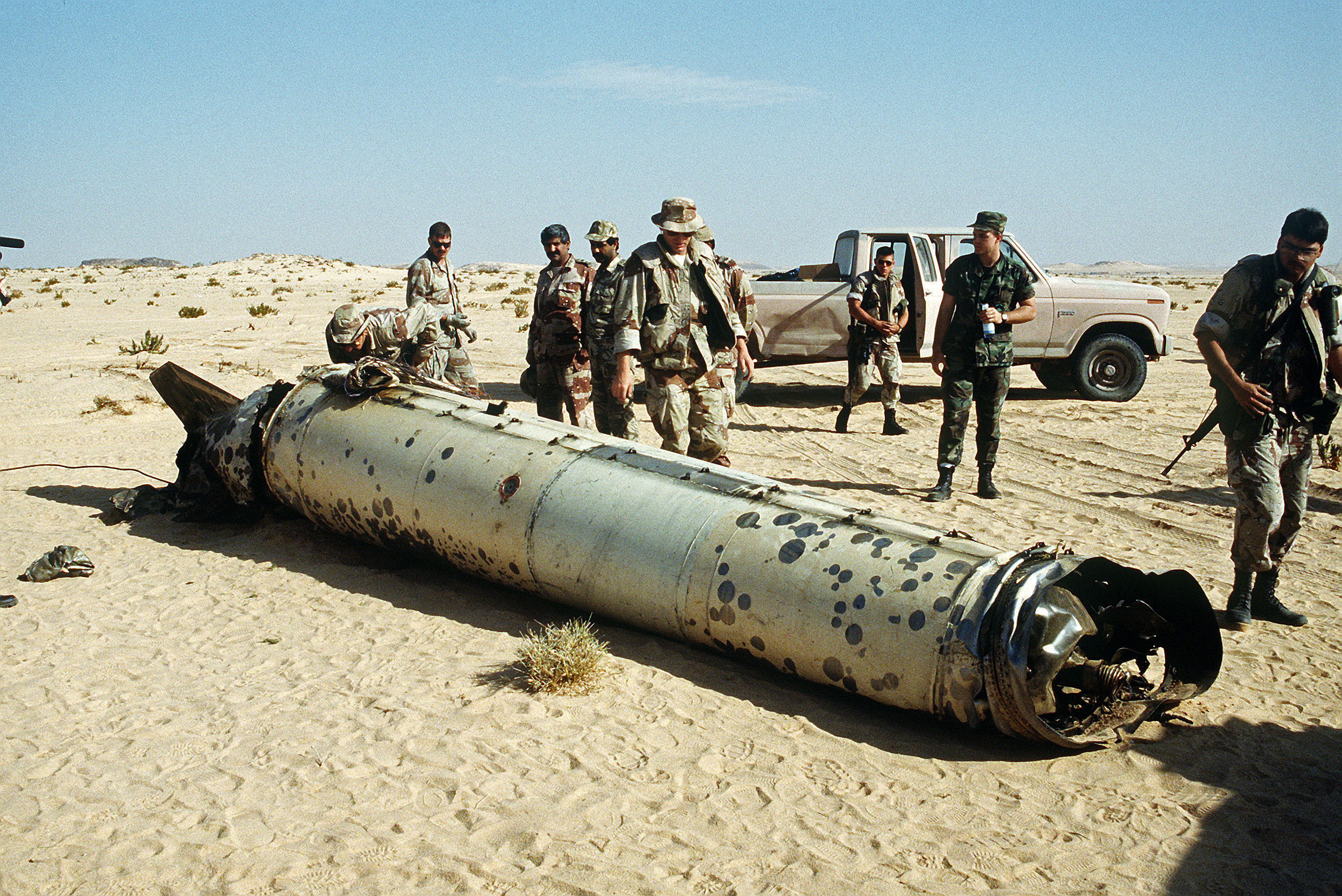 Military personnel examine a Scud missile shot down in the desert by an ...