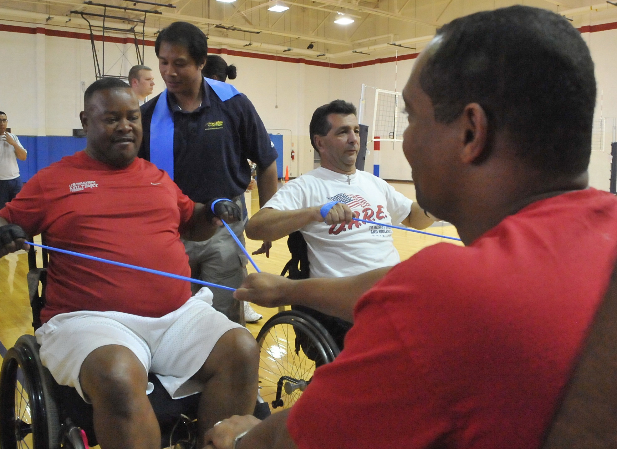 Mac Cole (facing)works with Andre Shelby on strength training during ...