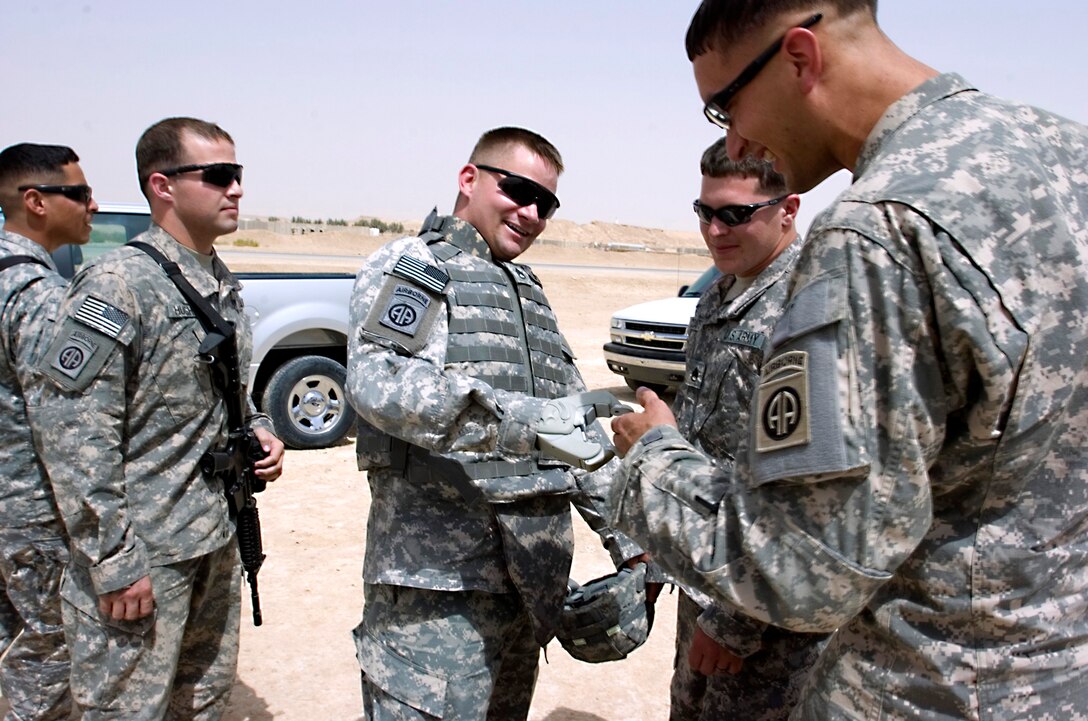 U.S. Army Staff Sgt. Kenneth Butler meets with the troops with whom he ...