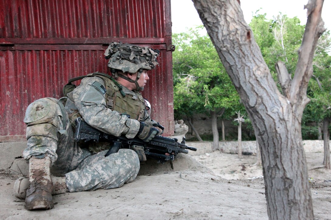 A U.S. Army paratrooper provides outer security while a group of Afghan ...