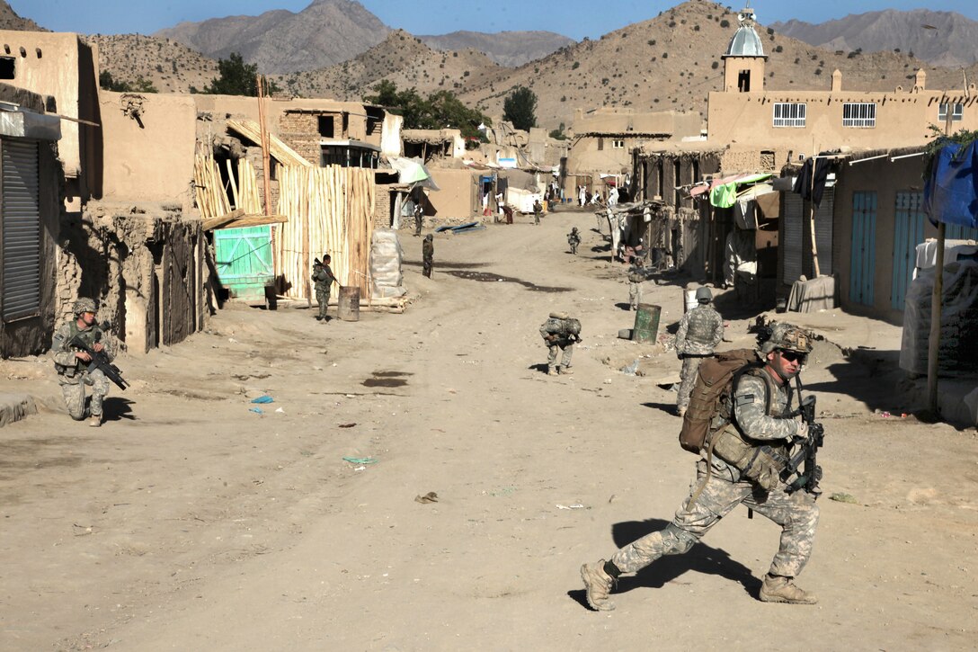 U.S. Army paratroopers stand back up after a tactical halt while on ...