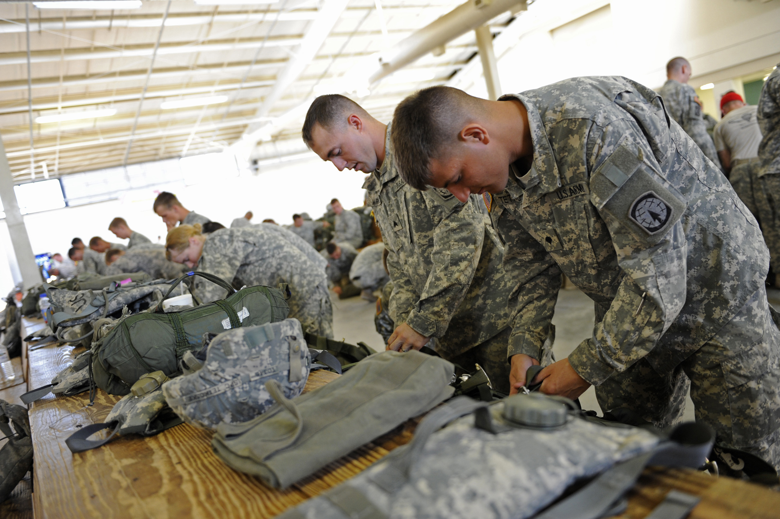 U.S. Army paratroopers with the 82nd Airborne Division inspect their ...