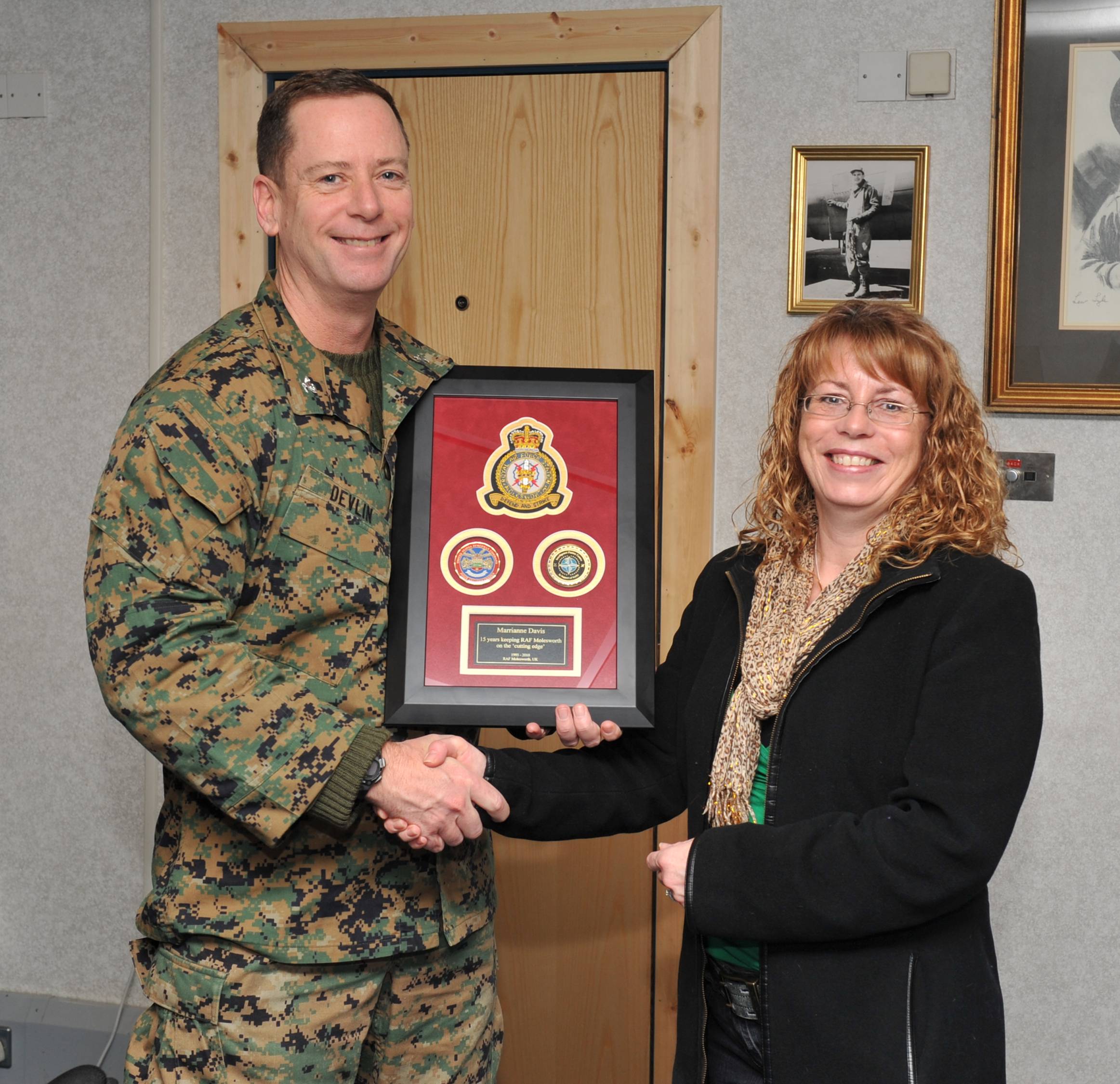 Col. Pete Devlin presents a plaque to Ms. Marrianne Davis