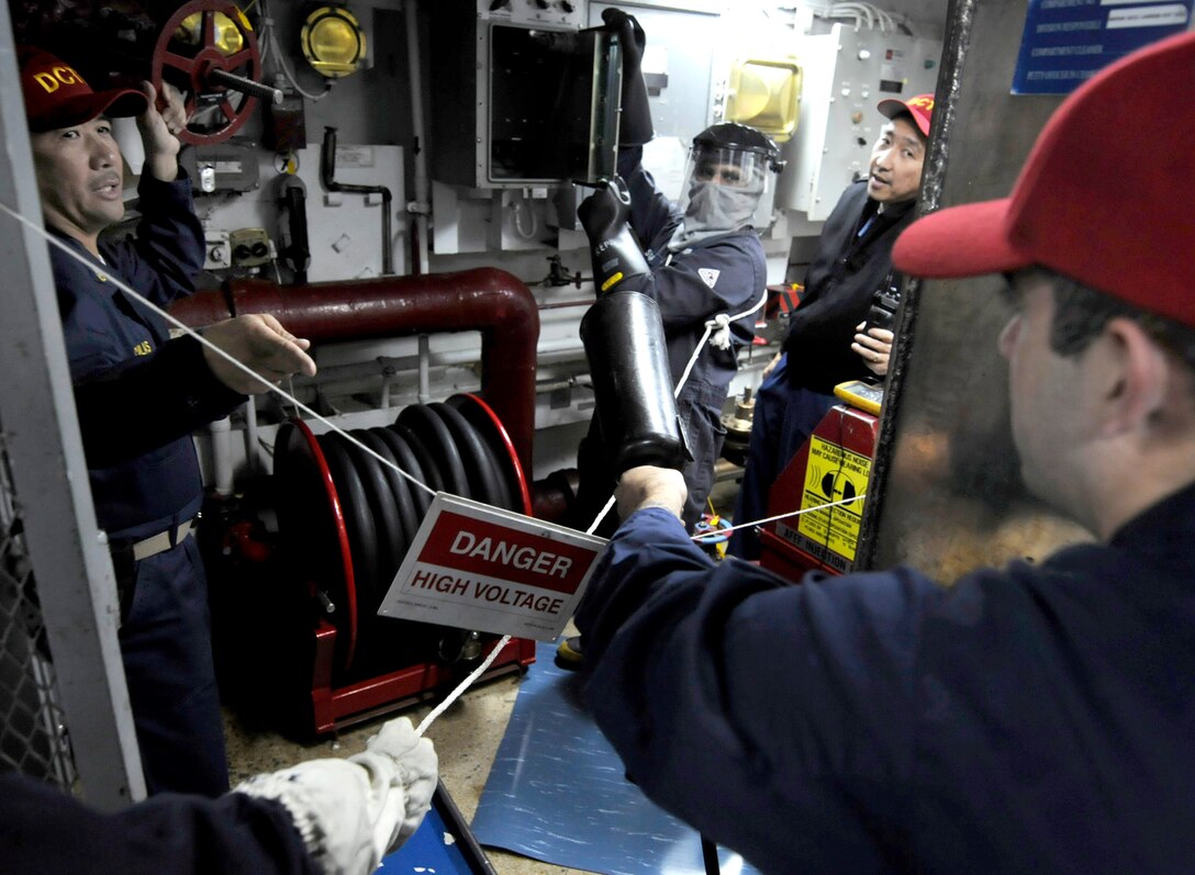 U.S. Navy Chief Petty Officer Mateo Canlas, left, and Master Chief ...