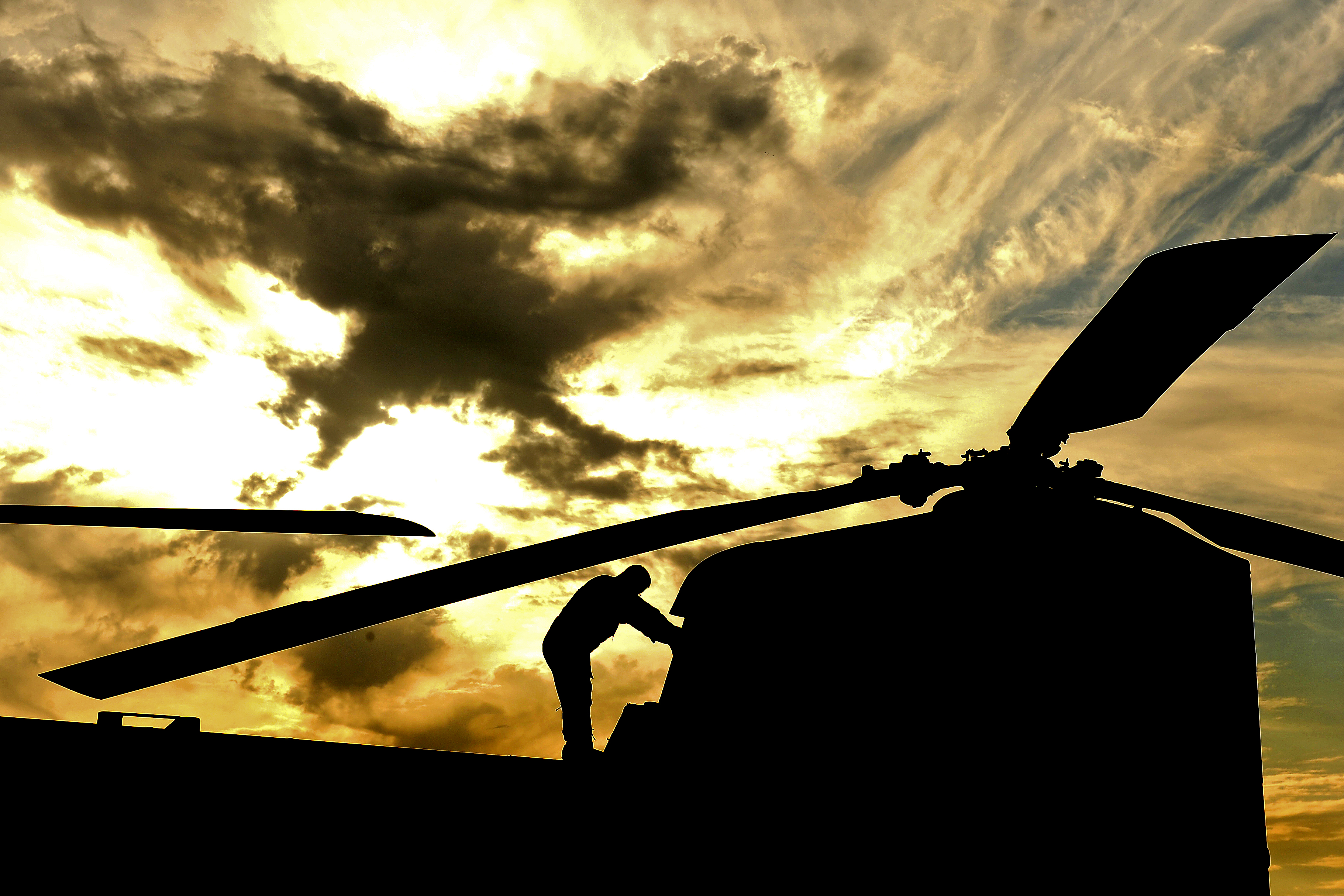 A U.S. Army CH-47 Chinook helicopter crew chief prepares to conduct a ...