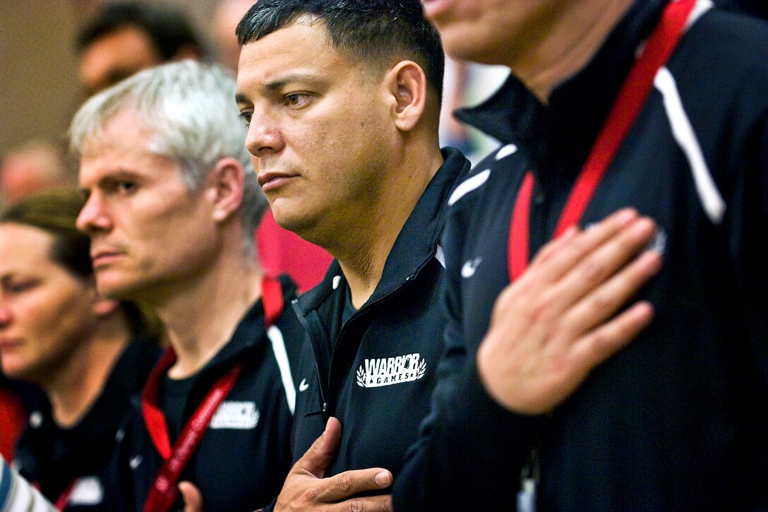 U.S. Army Spc. Israel Laboy places his had over his heart during the ...