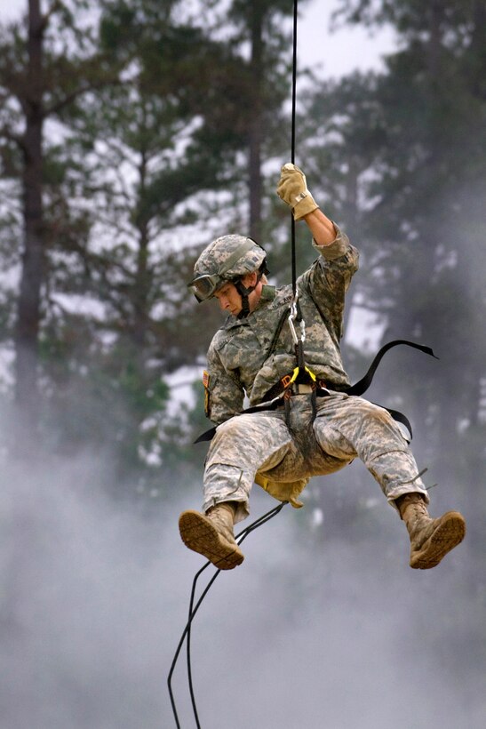 U.S. Army Sgt. Michael Malchow descends to the bottom of the rappel ...