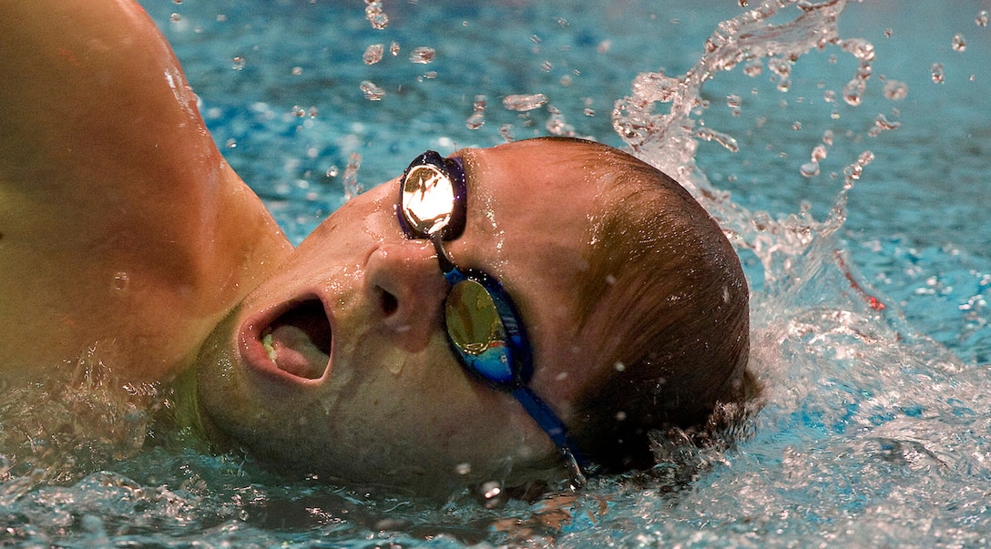 An Army swimmer competes in the 50-yard free style preliminary meet at ...