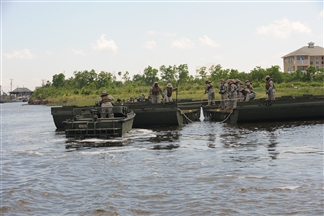 U.S. Army soldiers construct a 300-foot temporary wharf.