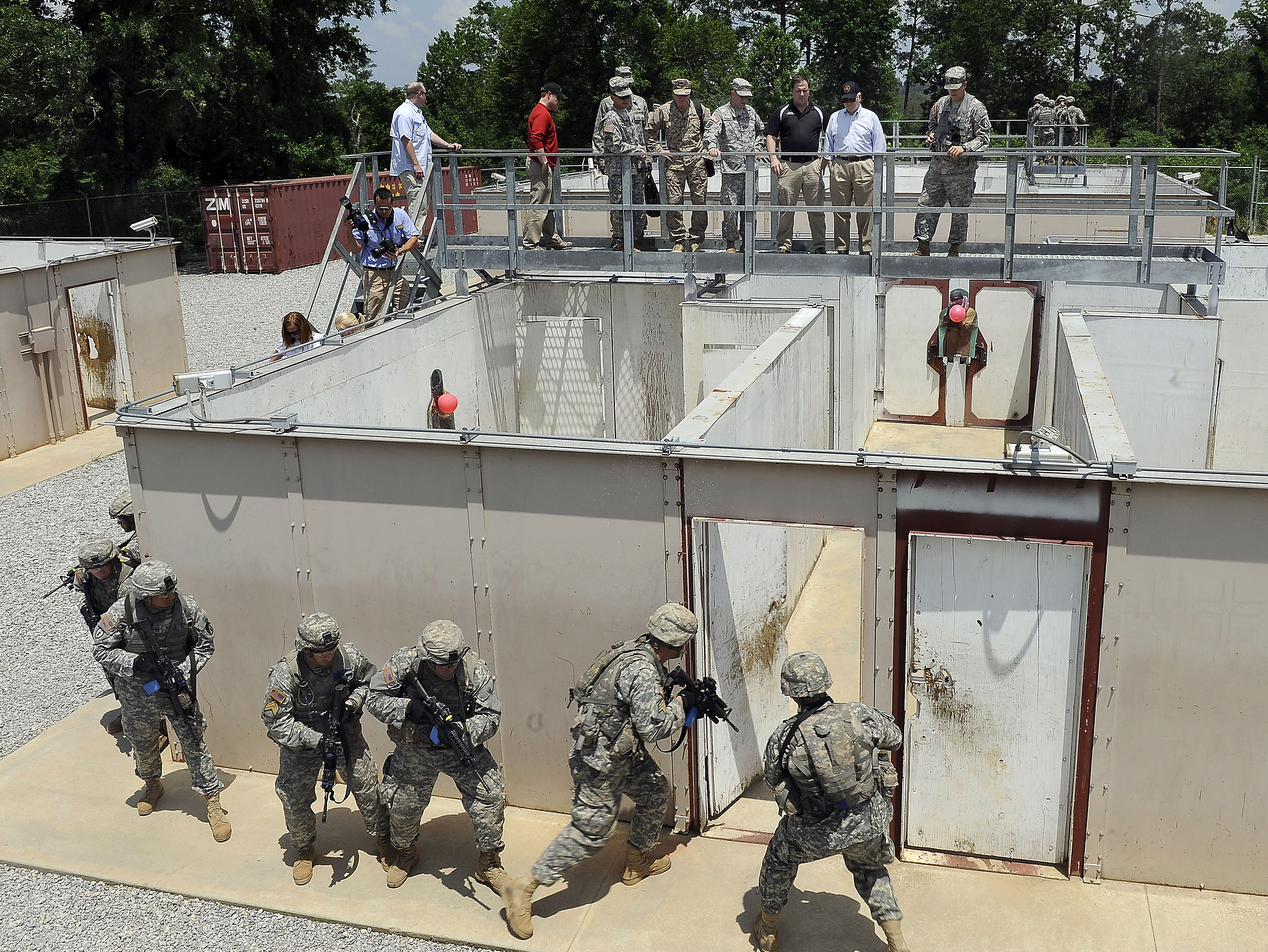 Defense Secretary Robert M. Gates watches soldiers practice a close ...