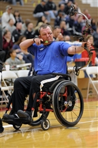 Staff Sgt. Rick Pollock lines up a shot while competing in the compound ...