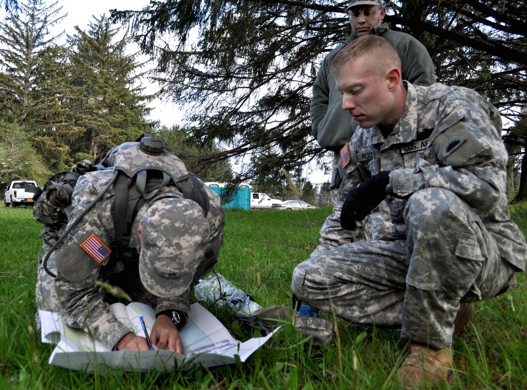 U.S. Army Pfc. Matthew Fry, left, plots his points for the land ...