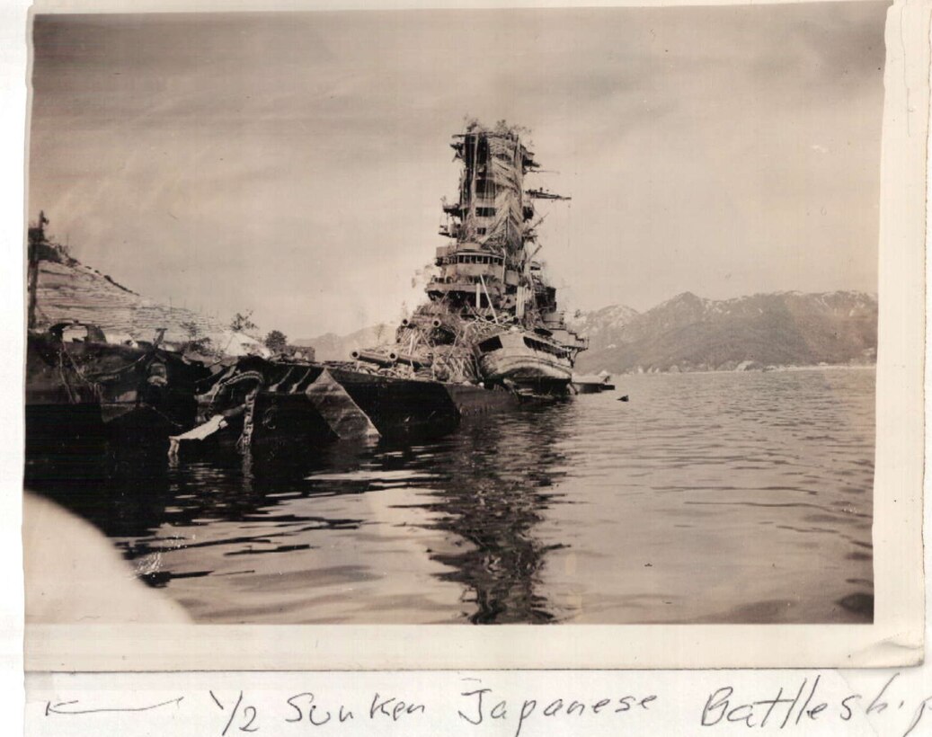 Shown is a half-sunken Japanese battle ship.