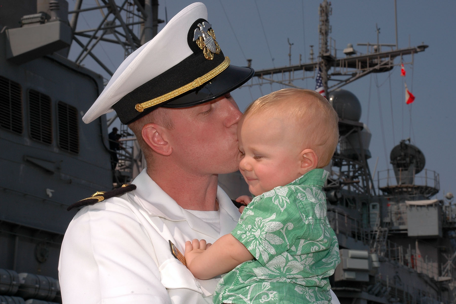 U.S. Navy Ensign Colin Lyman kisses his nine-month-old son during a ...