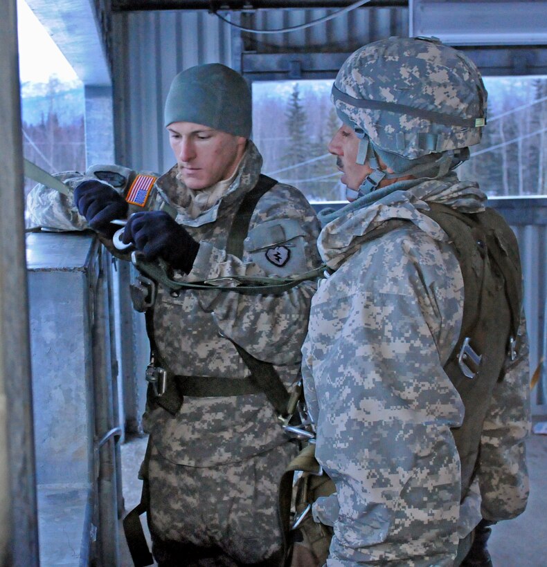 U.S. Army Staff Sgt. Michael Cavallo clips an Indian soldier to a zip ...