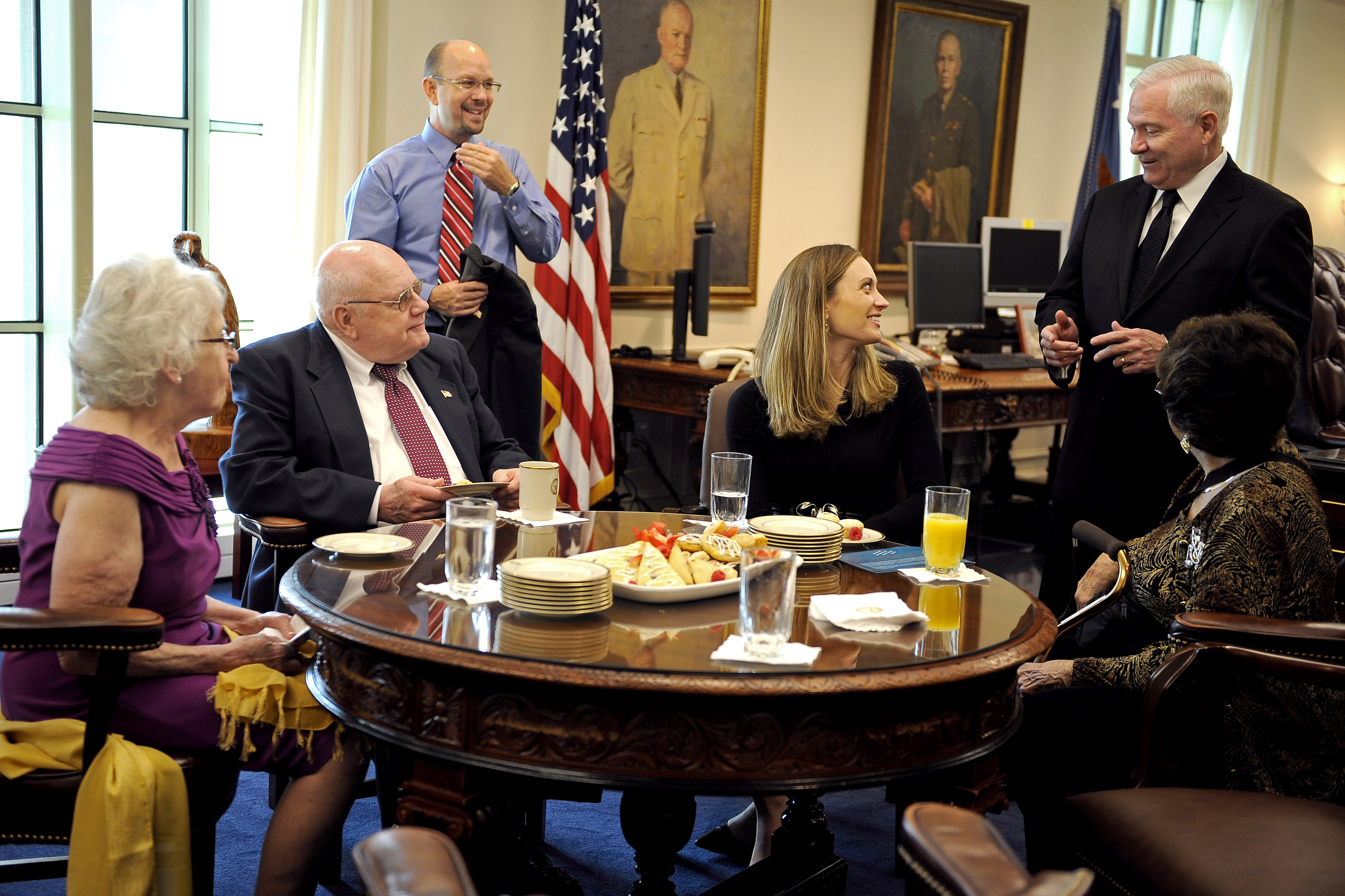 Defense Secretary Robert M. Gates speaks to Jennifer Giunta, wife of ...