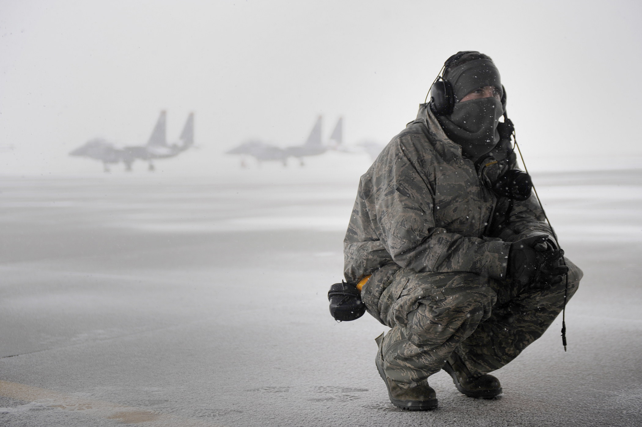 Airmen work under harsh weather conditions