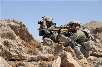U.S. Army soldiers look for suspicious activity from an observation ...