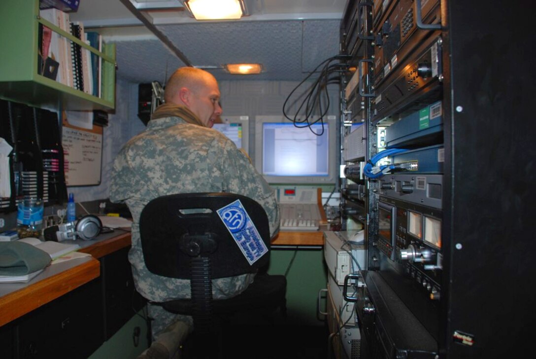 U.S. Army Staff Sgt. Michael Cox broadcasts from the production vehicle ...