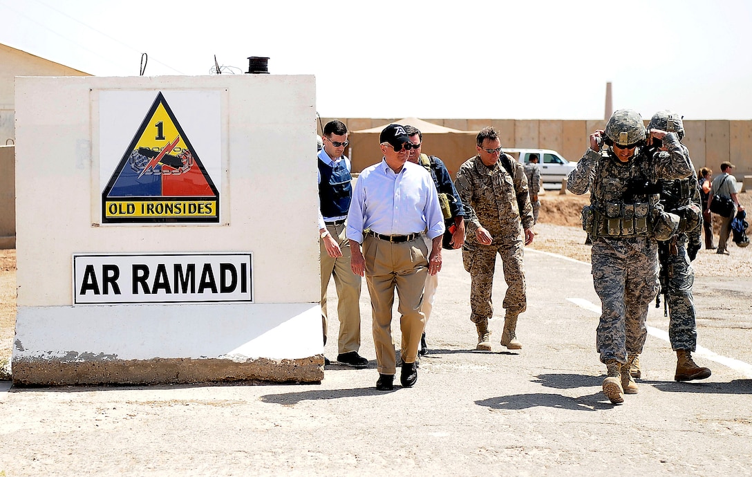 U.S. Defense Secretary Robert M. Gates departs after visiting troops on ...
