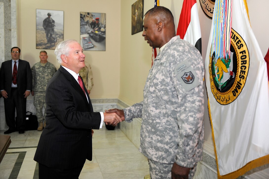 U.S. Defense Secretary Robert M. Gates congratulates U.S. Army Gen ...