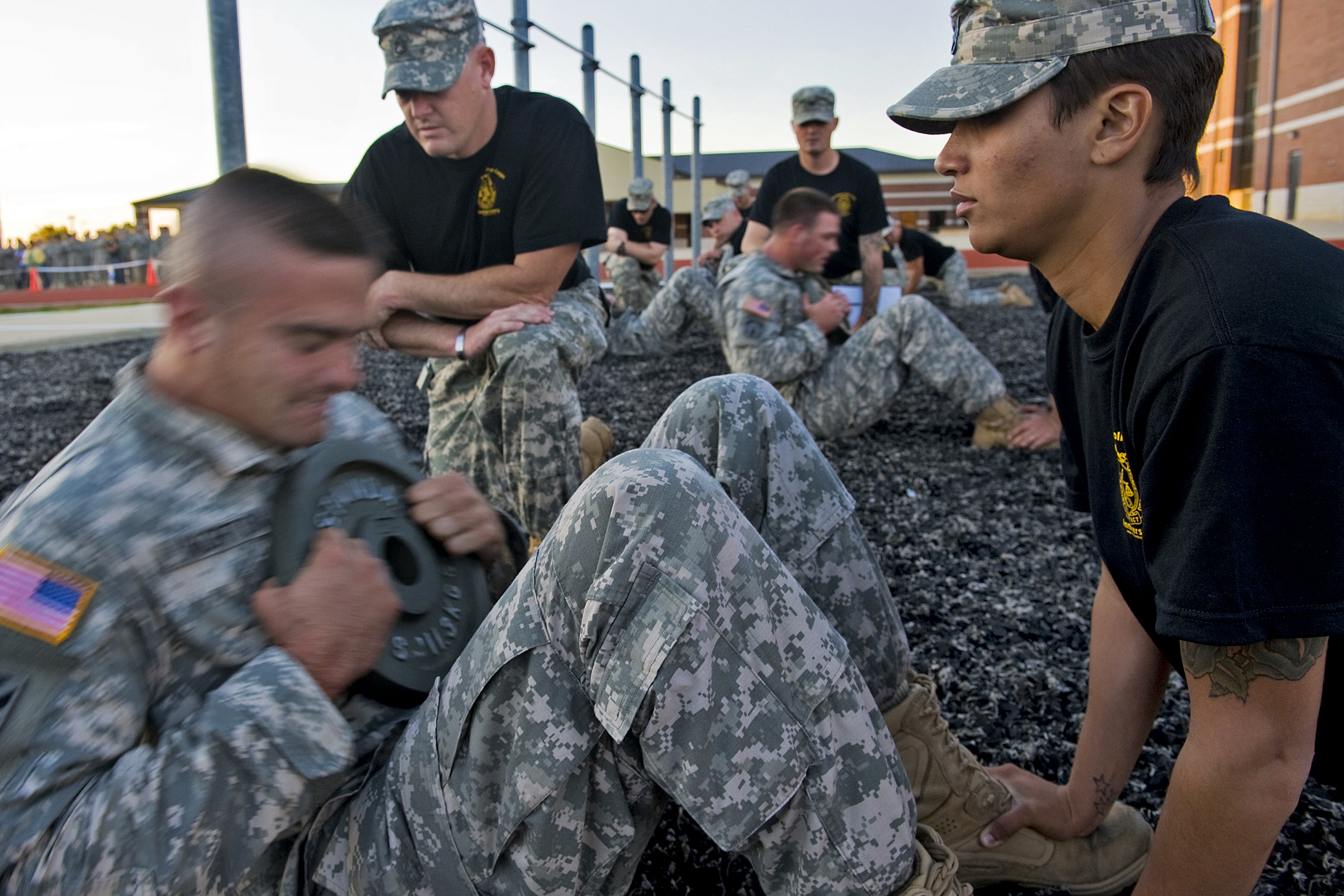 U.S. Army soldiers hold twenty-five pound weights to their chest while ...