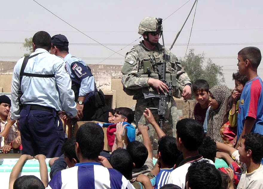 Joshua Mantz speaks with Iraqi children while on patrol near Sadr City ...