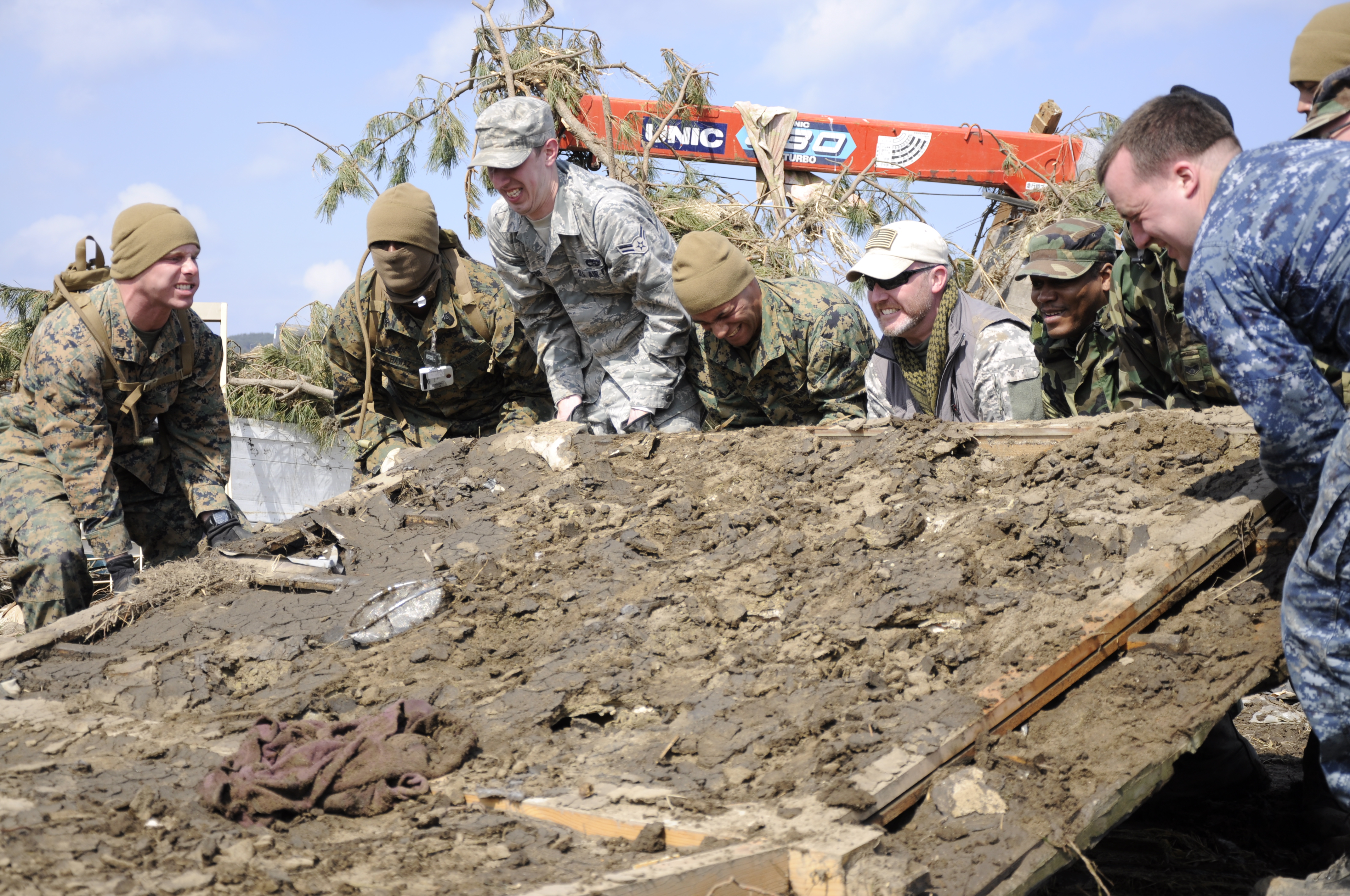 Photo essay: Military volunteers assist tsunami-struck village