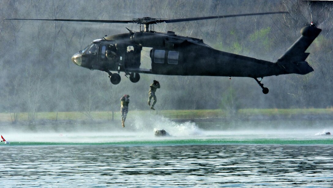 U.S. Army engineers or "sappers" jump from a hovering UH-60 Black Hawk ...