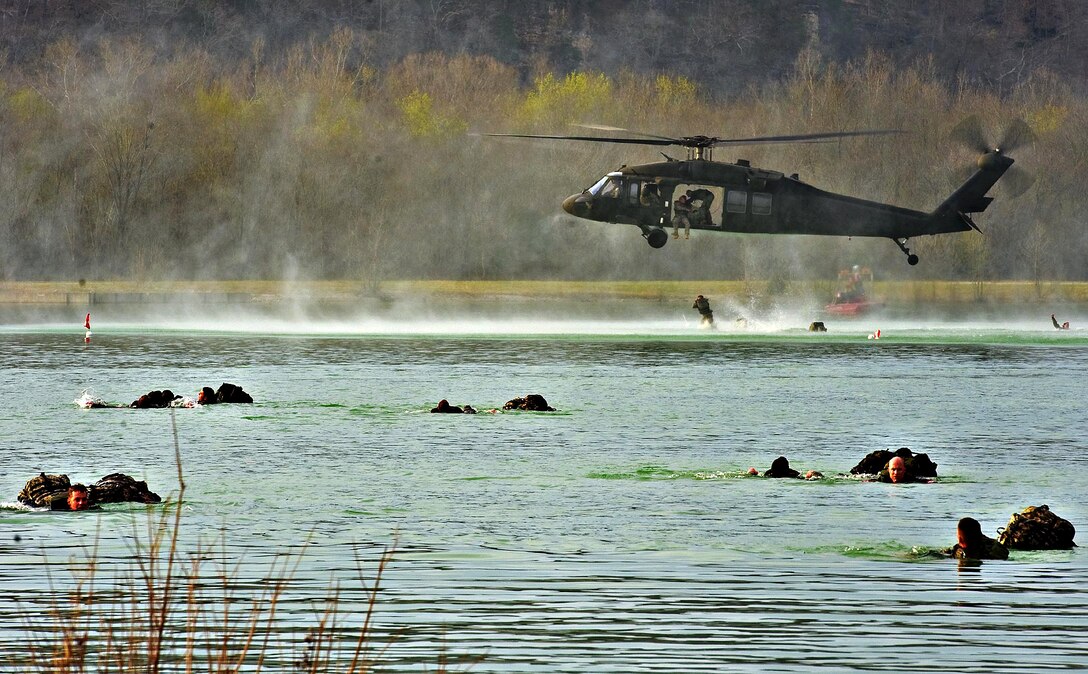 U.S. Army engineers or "sappers" jump from a hovering UH-60 Black Hawk ...