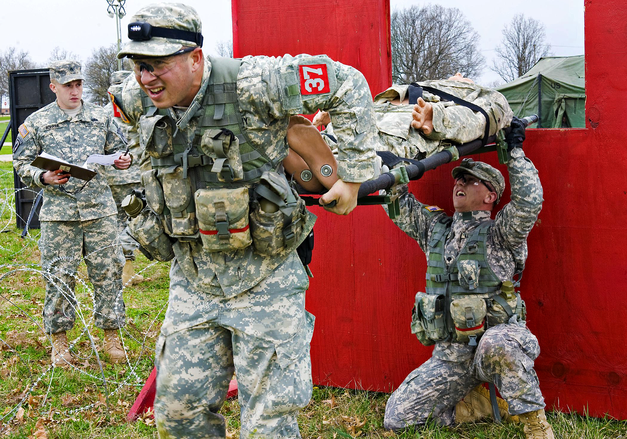 U.S. Army engineers or "sappers" evacuate a soldier over an obstacle in ...