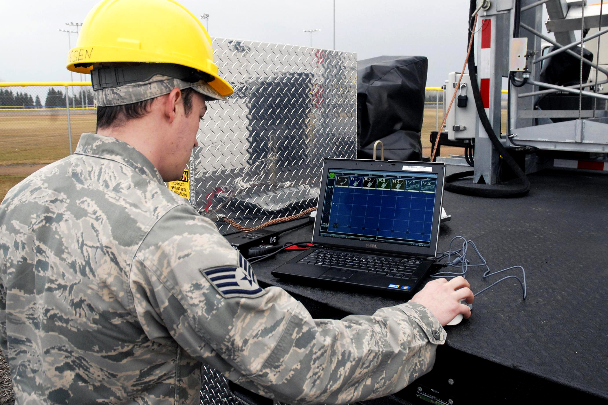 U.S. Air Force Staff Sgt. Joshua R. Niesen uses a remote communications ...