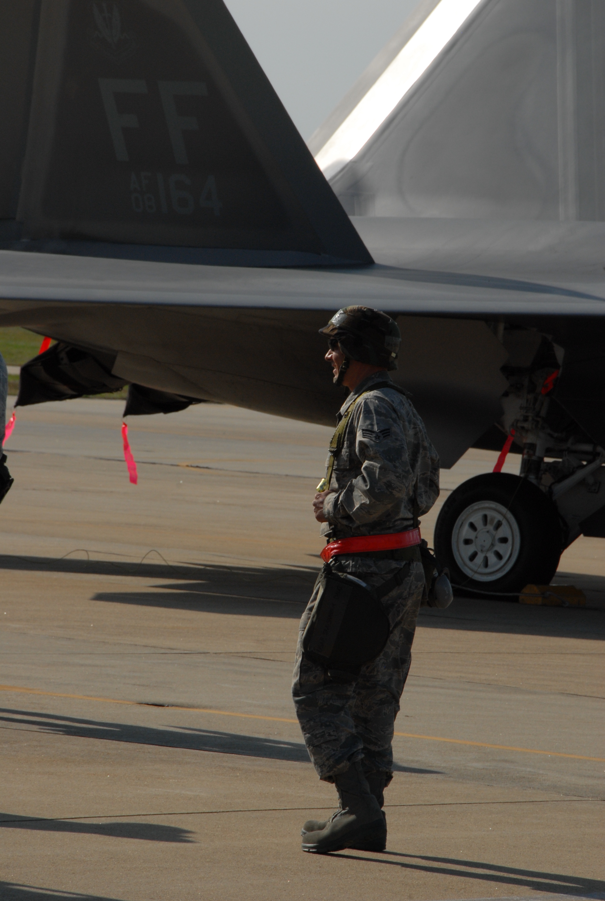192nd Fighter Wing maintainer walks toward F-22 Raptor.