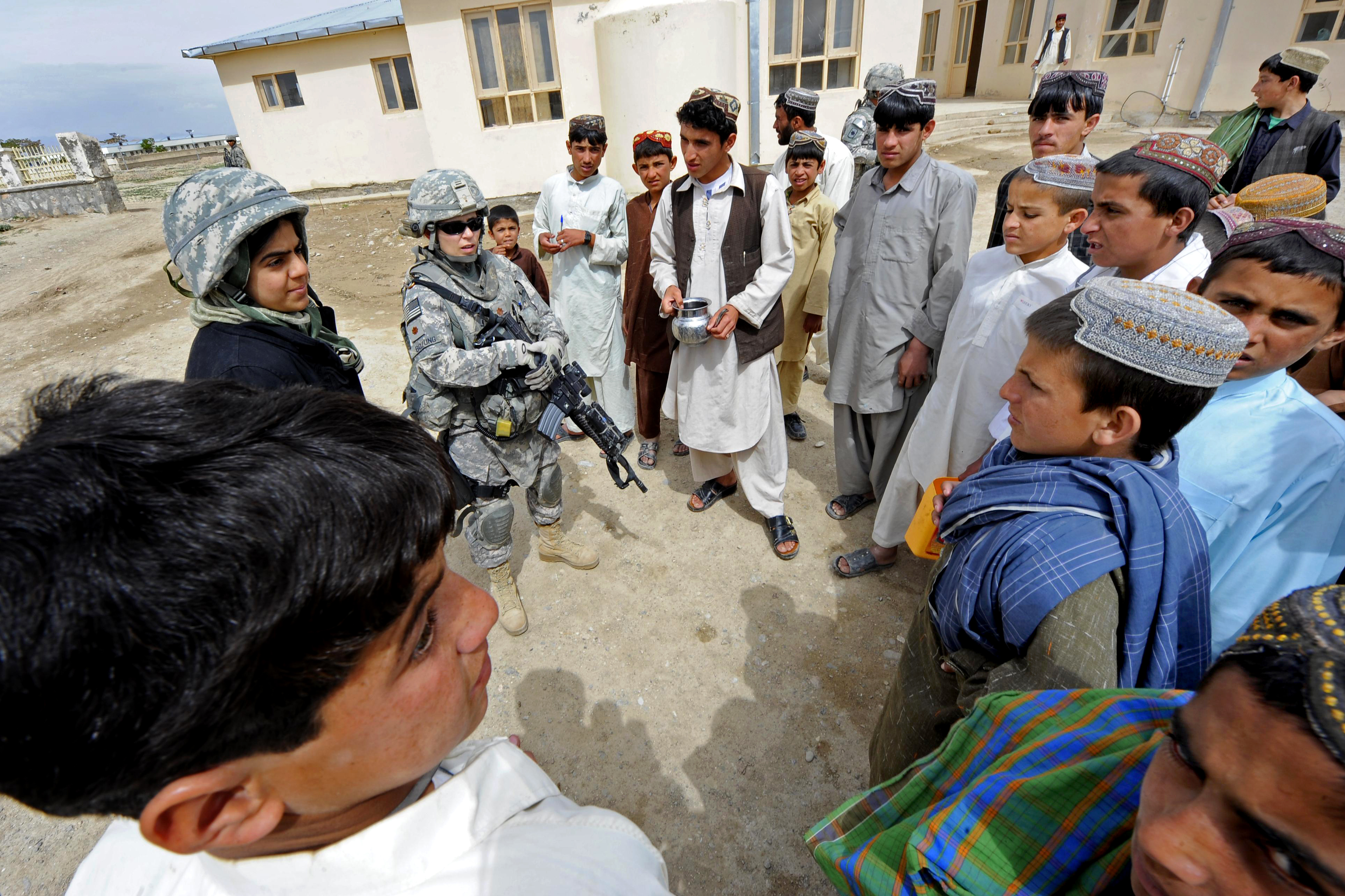 U.S. Army Maj. (Dr.) Tracy Bozung talks with children at the Sheik Mati ...
