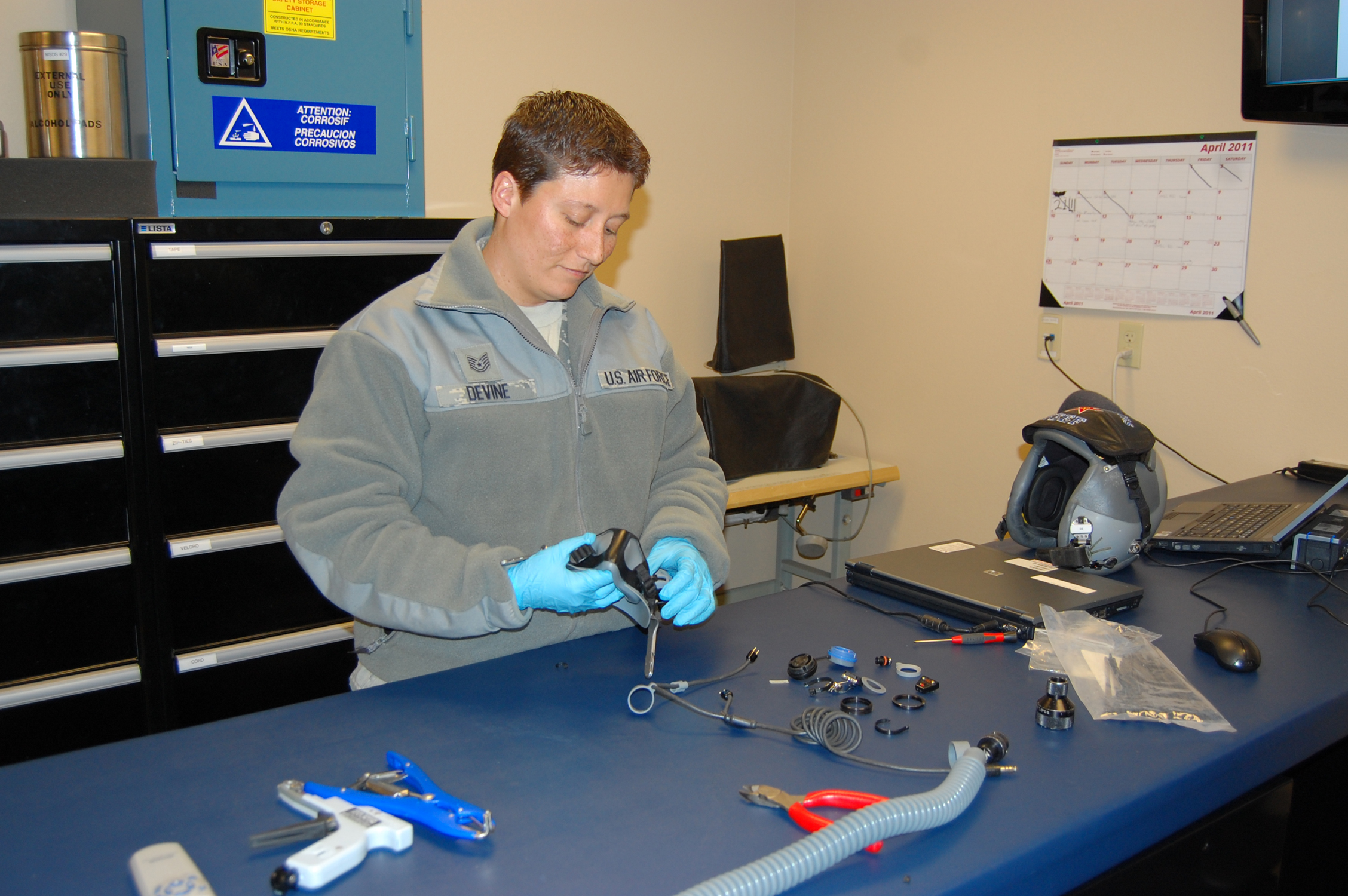 Tech. Sgt. Heather Devine conducts post-helmet inspection