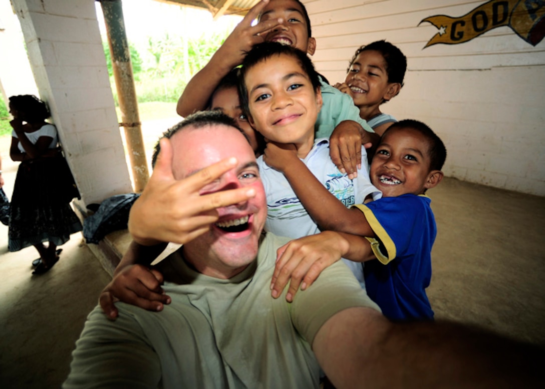 U.S. Air Force Tech. Sgt. Tony Tolley takes a group photo of himself ...