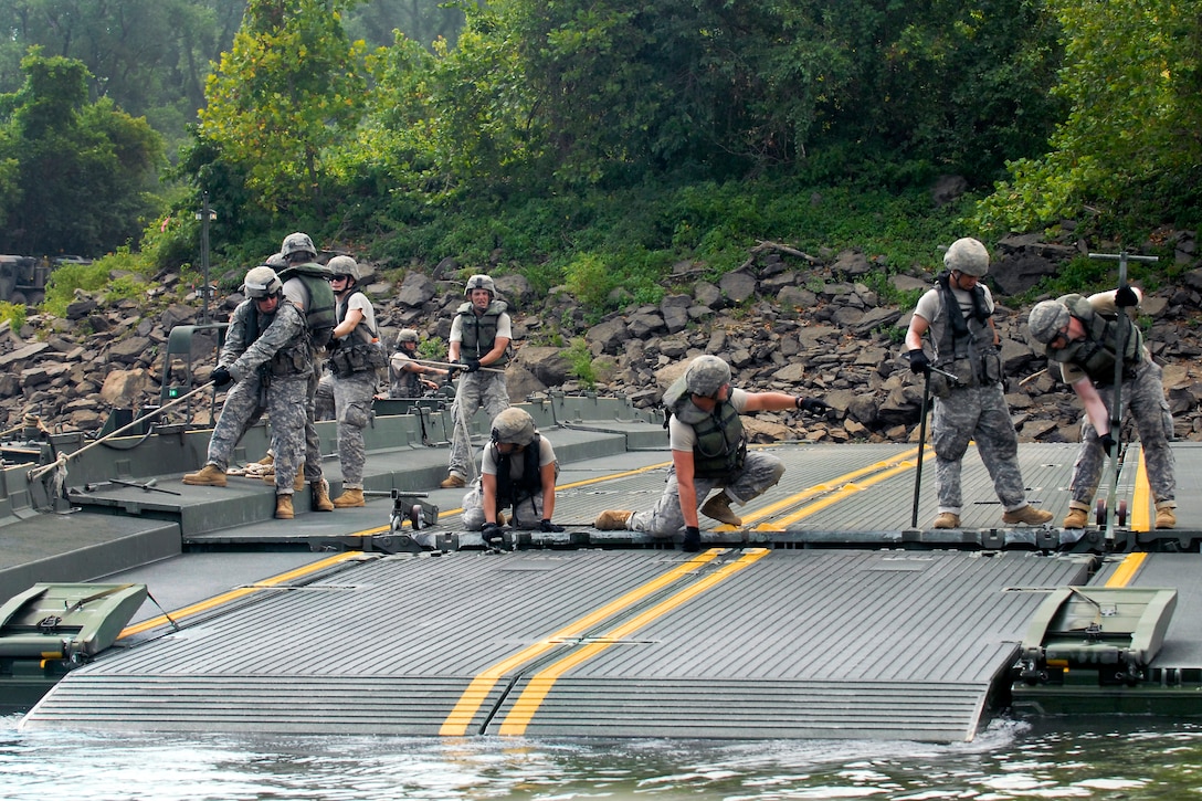 Army Reserve soldiers work to disconnect raft sections on the Arkansas ...