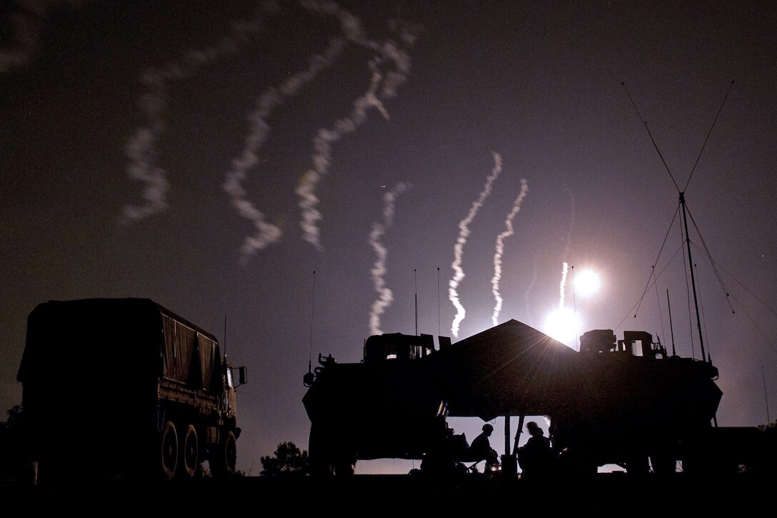 Army soldiers assigned to a combat observation lasing team call in ...
