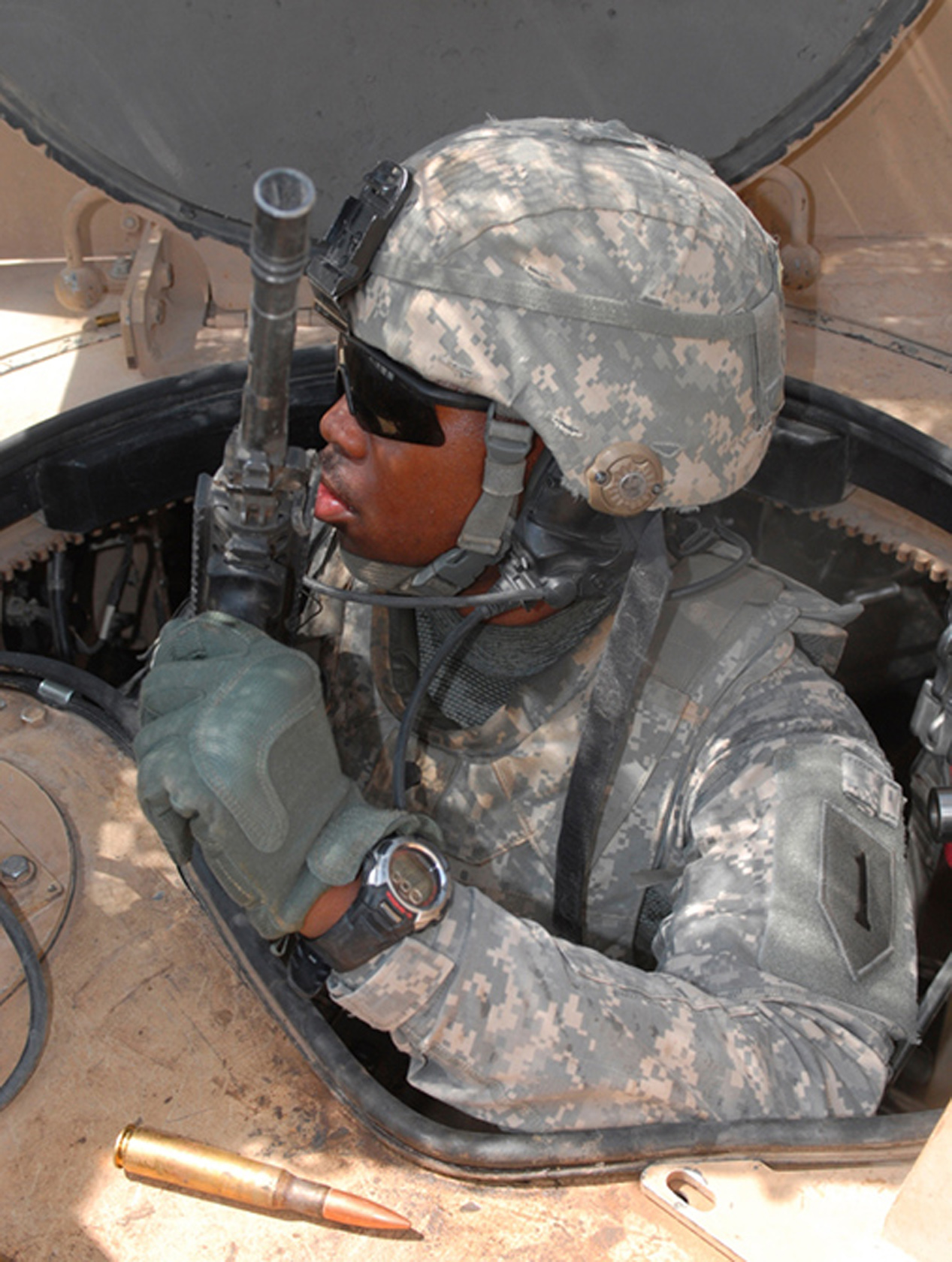 Army Spc. Alvin Anderson enters the gunner’s turret to observe movement ...