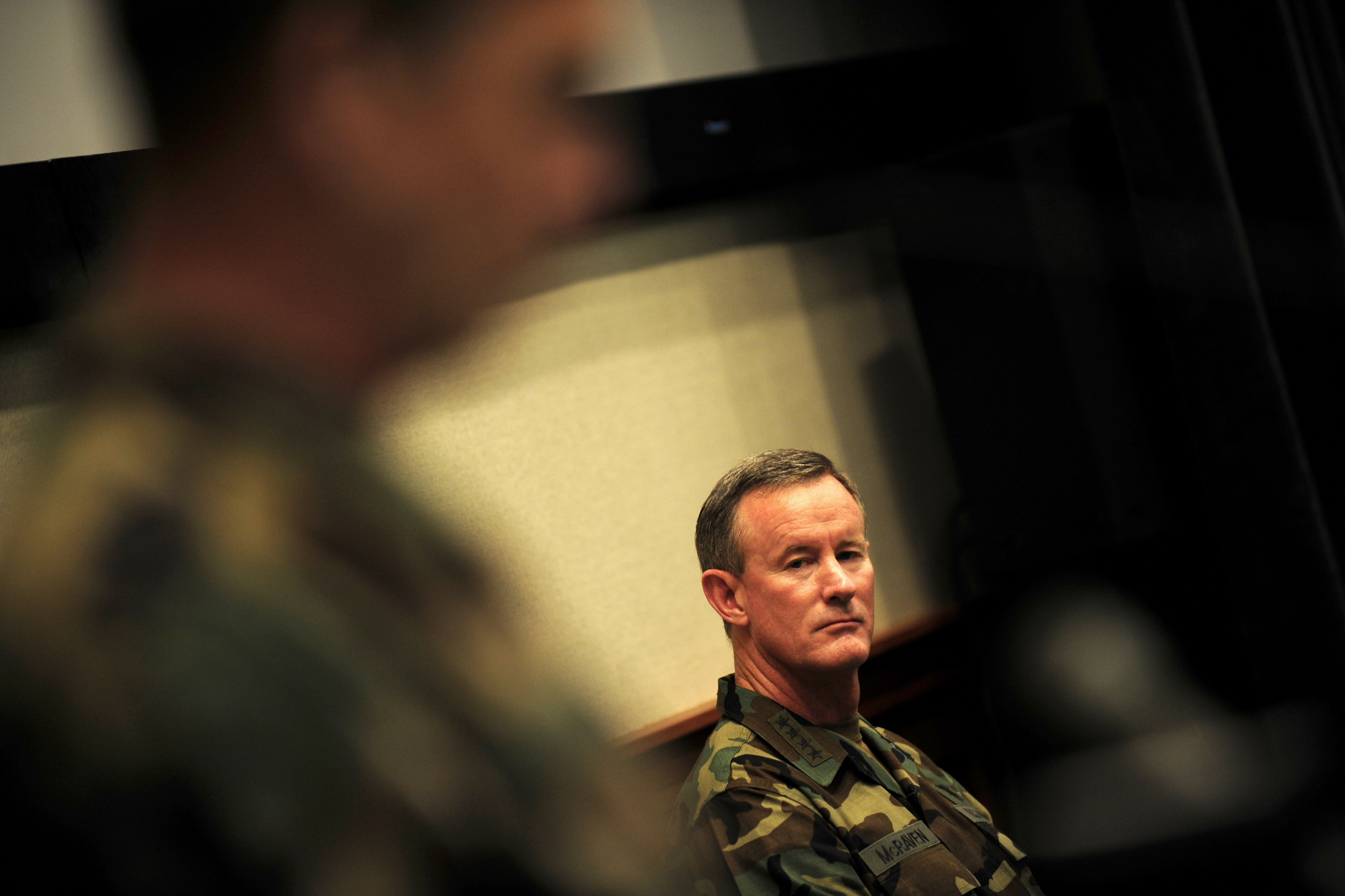 Navy Adm. William H. McRaven listens as Navy Adm. Eric T. Olson ...