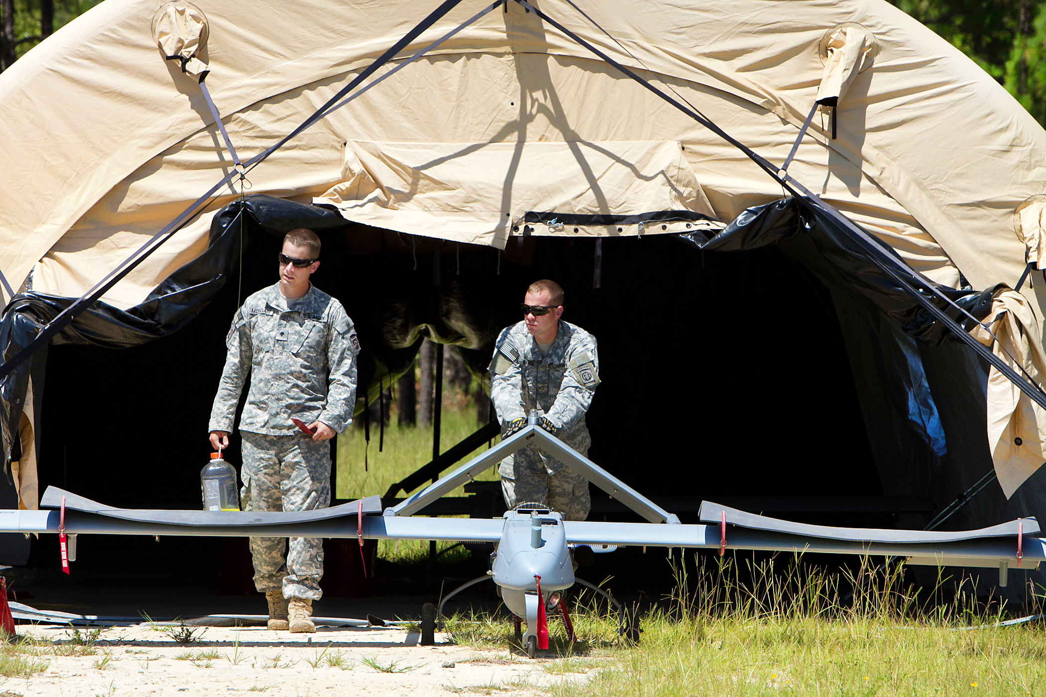 Army Pfc. Daniel Graham wheels a Shadow 200 unmanned aerial vehicle ...