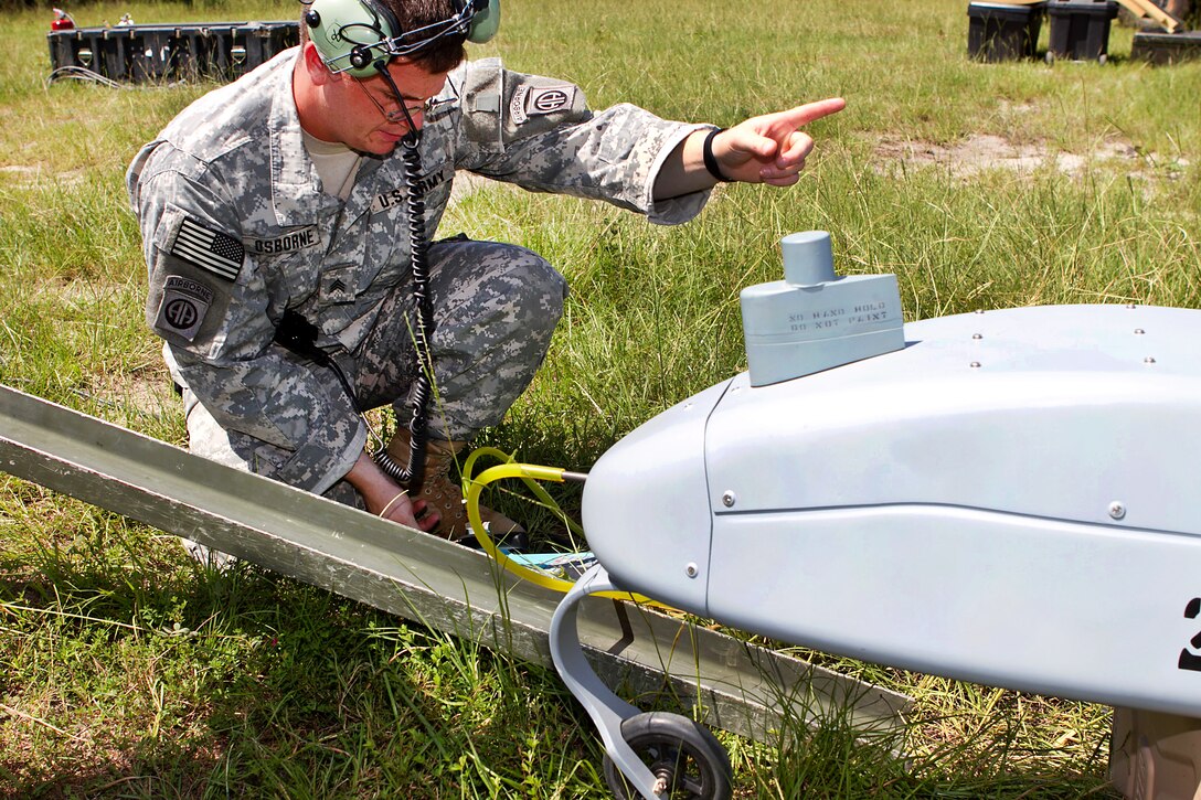 Army Sgt. Jason Osborne begins preflight checks on a Shadow 200 ...