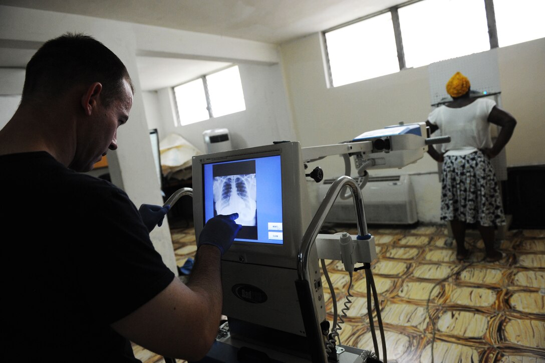 U.S. Air Force Lt. Cmdr. Andrew Sellers reviews an X-ray at the Killick ...