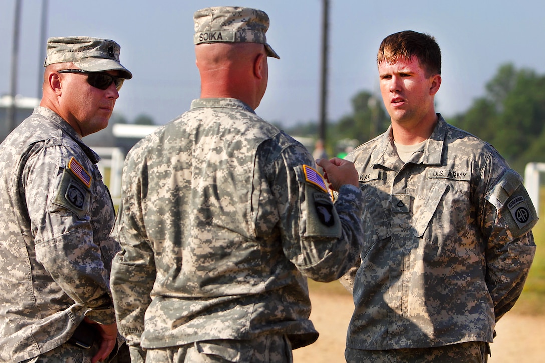 Army Pfc. Anthony Makar is interviewed by Army Capt. Tony Soika, right ...