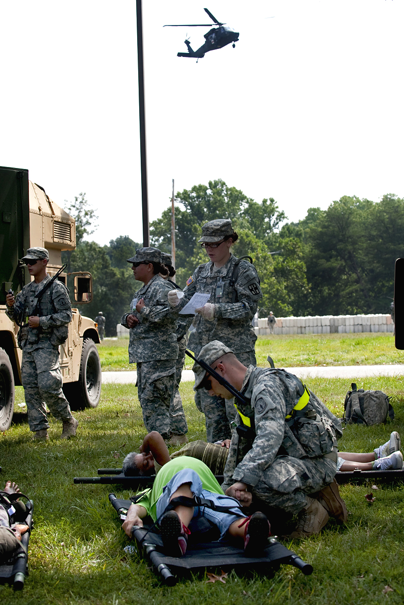 A UH-60 Black Hawk medevac helicopter hovers overhead as medics assist ...