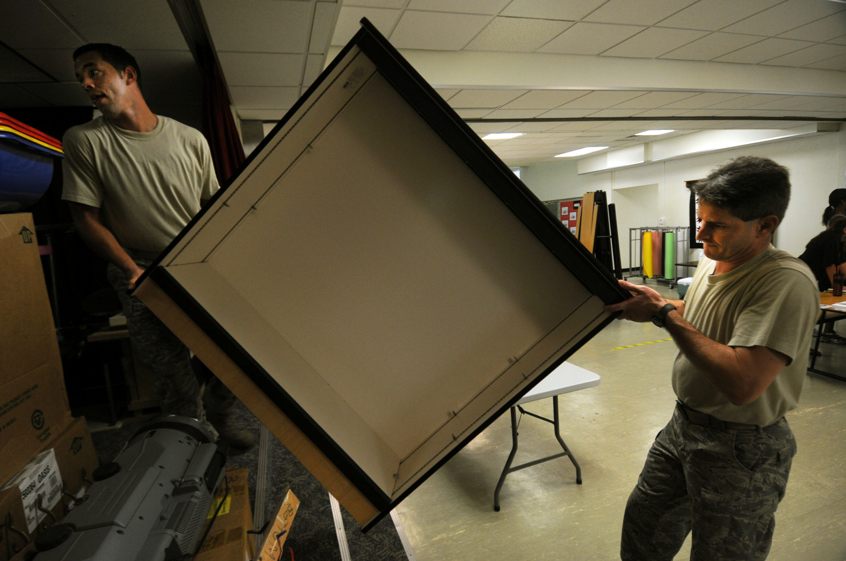 Airmen work together to prepare classrooms for elementary students ...