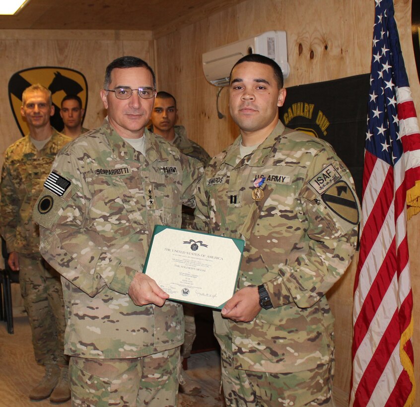 Army Capt. Dennis Edwards, right, an operations officer assigned to ...