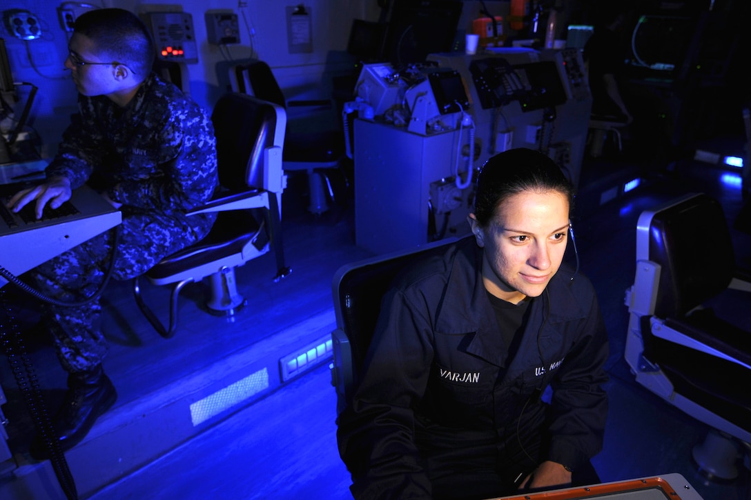 U.S. Navy Seaman Sarah Varjan stands watch in the carrier air traffic ...