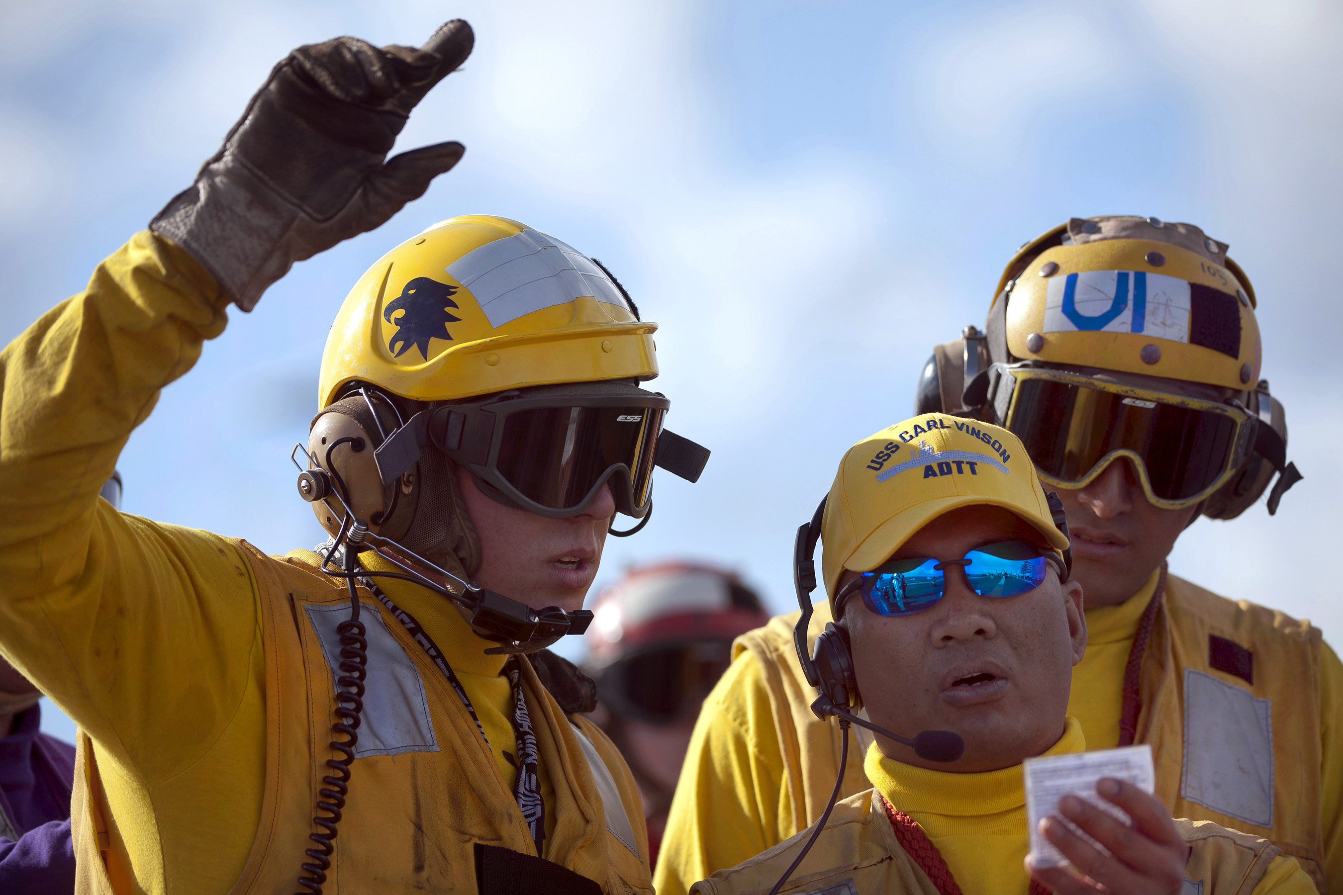 U.S. Navy Senior Chief Petty Officer Terry Libed, center, instructs ...
